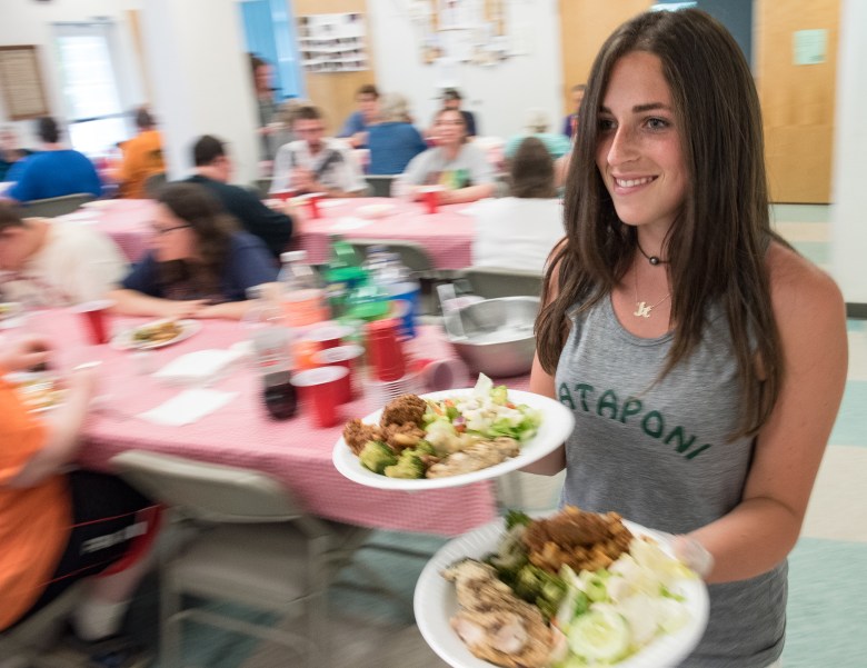 Campers serve dinner to Blake Street Towers residents